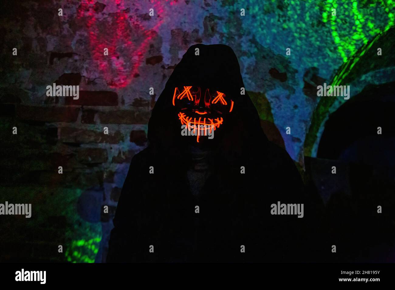 Man in creepy glowing mask in abandoned building. Horror concept Stock ...