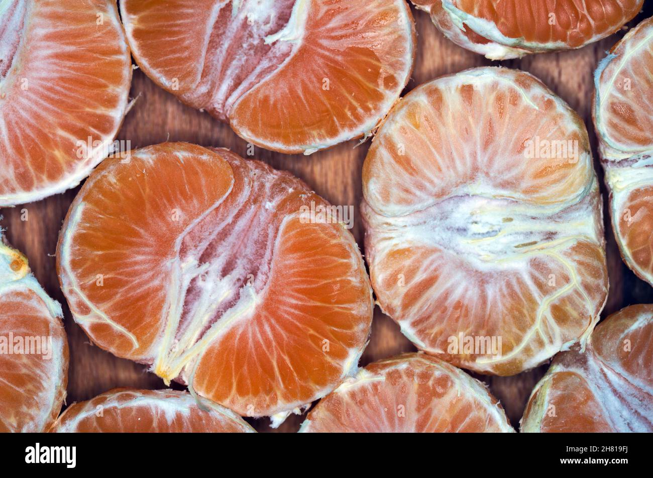 Tangerine segments, orange background texture Stock Photo - Alamy