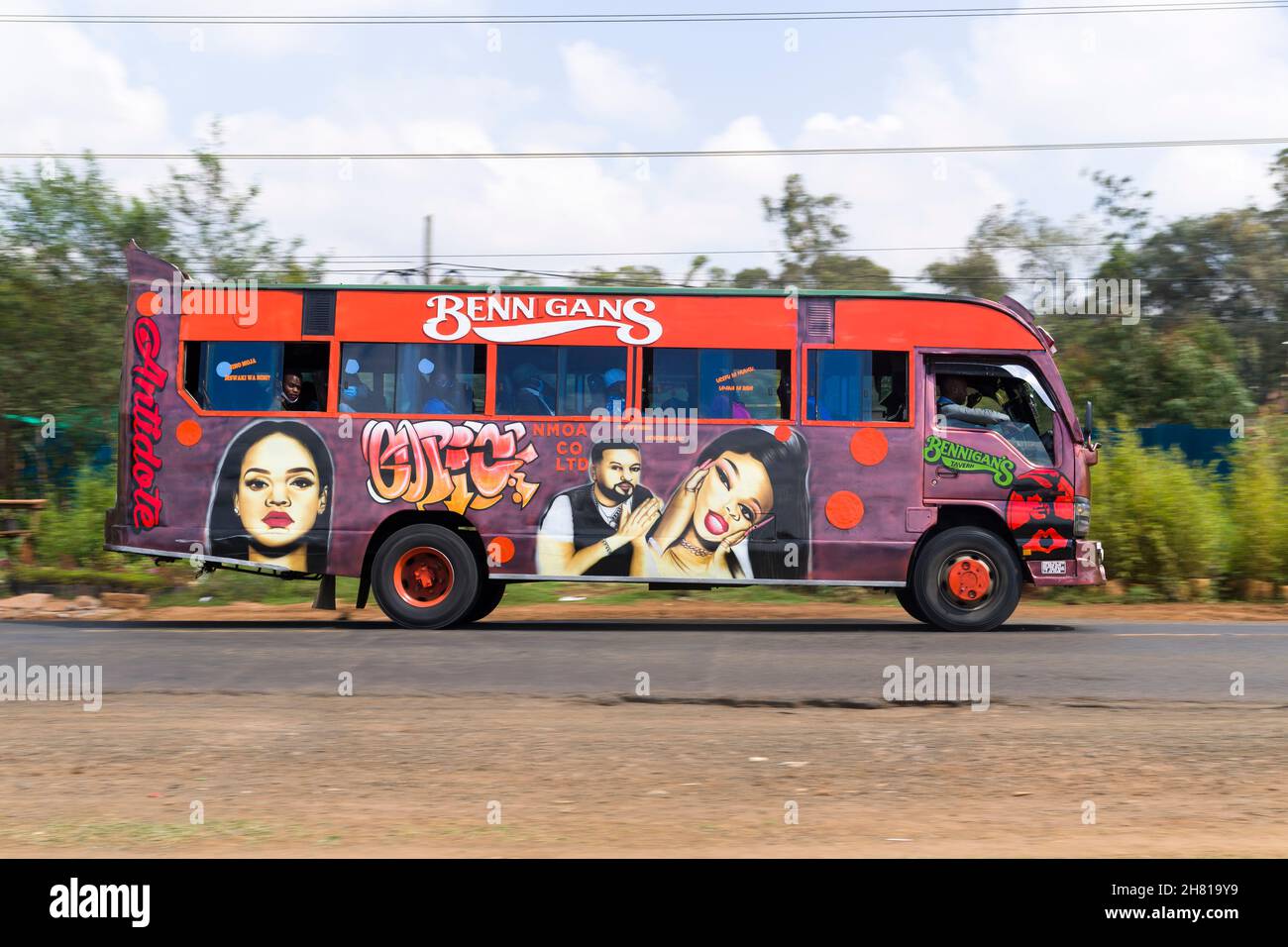Bus with customised paintwork driving along Ngong road. Many buses in ...