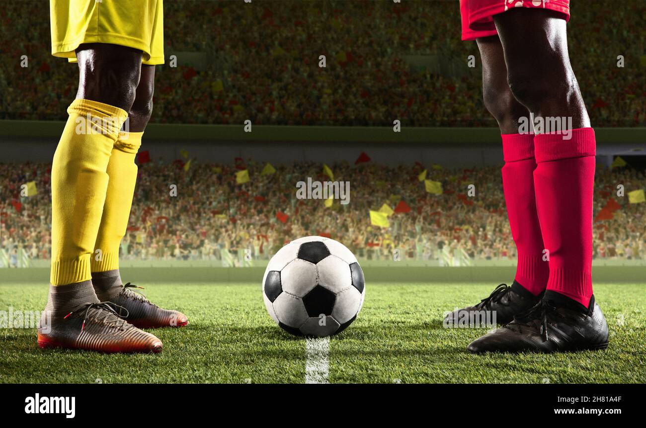 Cropped image of two male soccer, football players standing at crowded ...