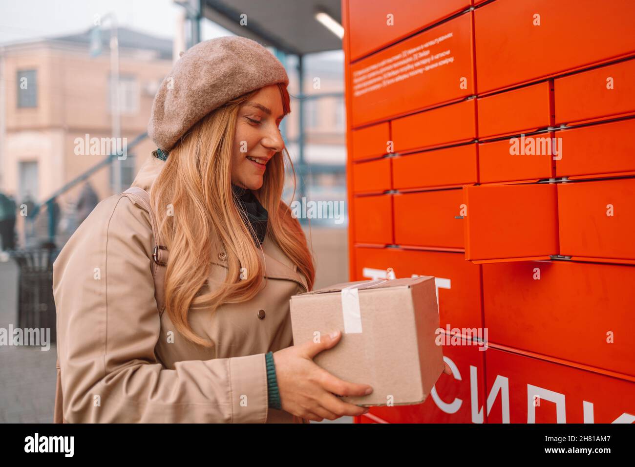 Putting carton box with shipping goods to self service postal case ...