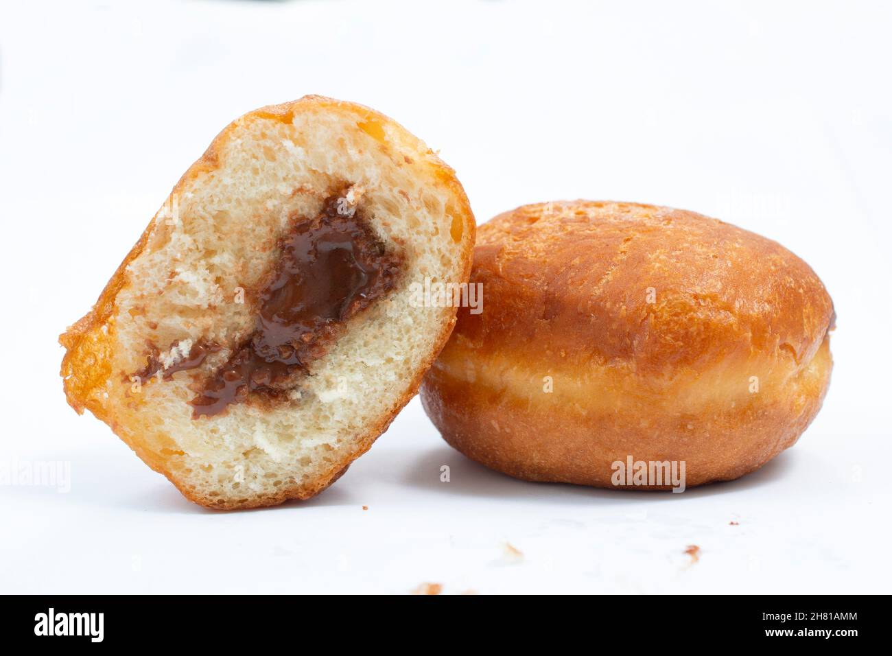 small round donuts with chocolate filling on white background Stock ...