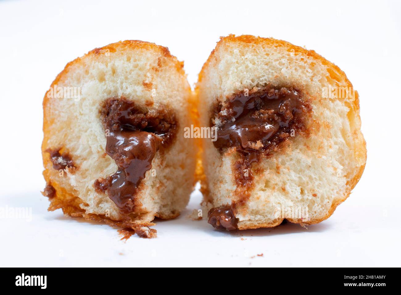 small round donuts with chocolate filling on white background Stock ...