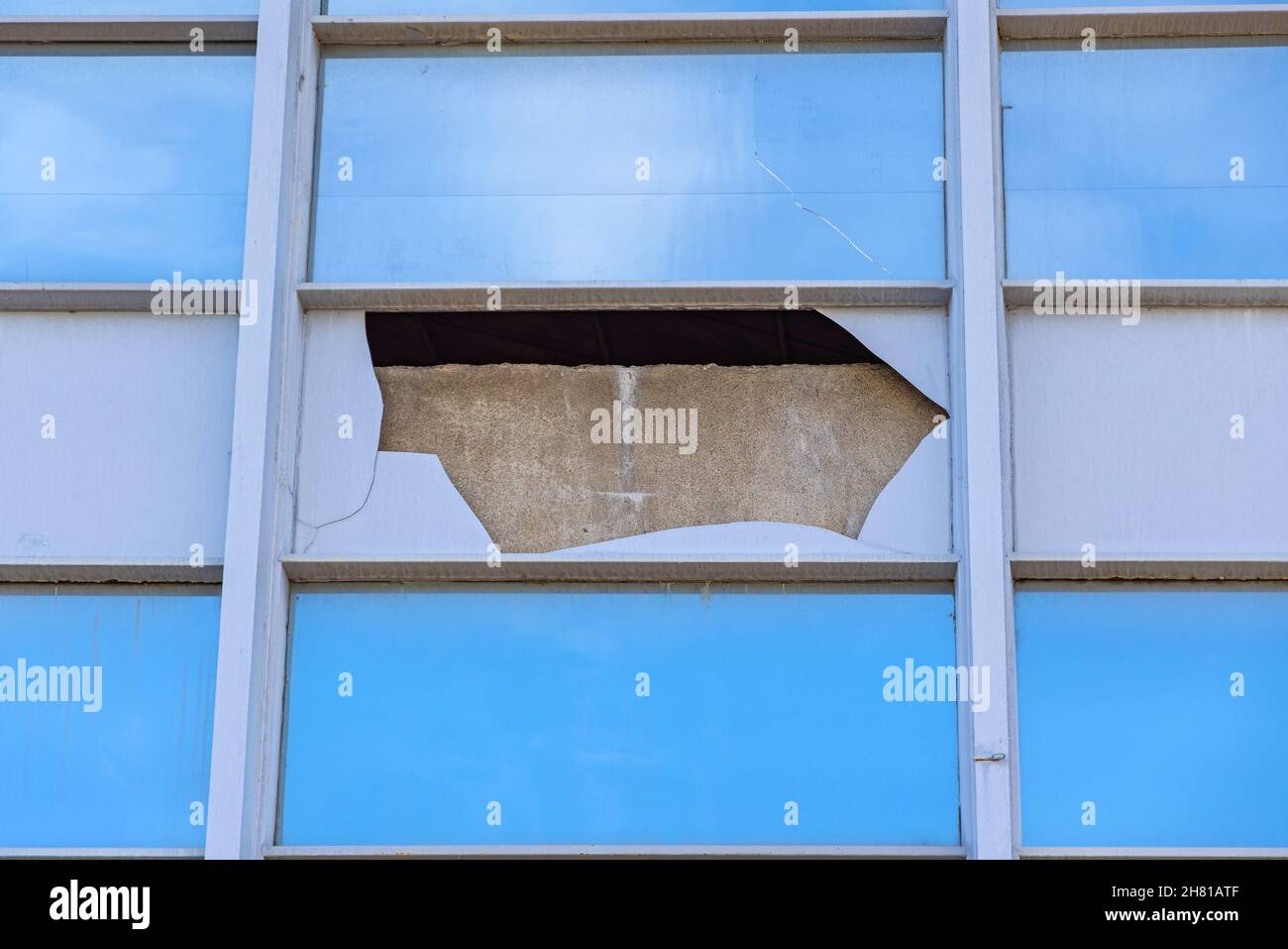 One Broken Window Glass at Big Hall Building Damage Stock Photo - Alamy