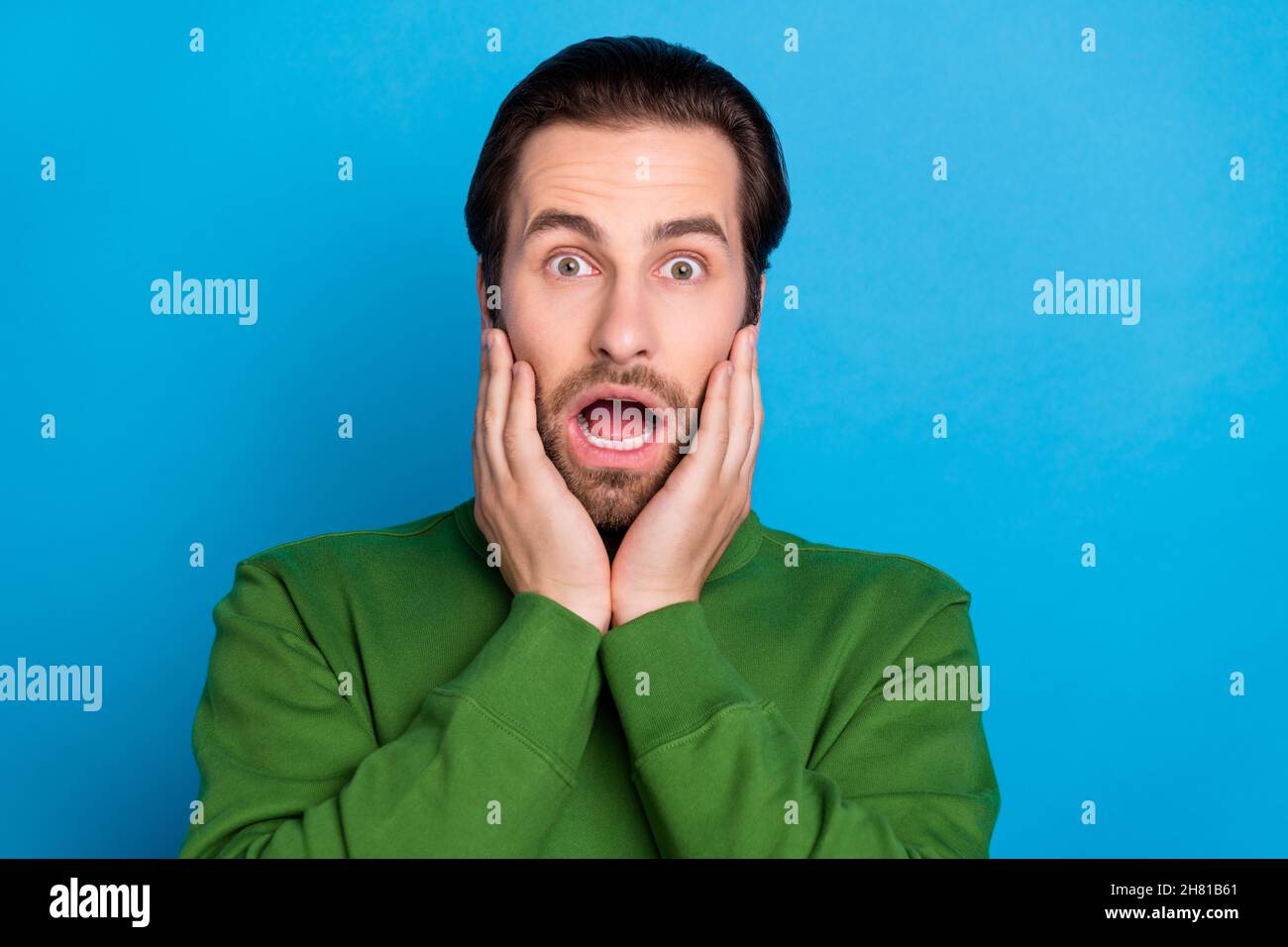 Photo of shocked young person hands on cheeks open mouth look camera ...