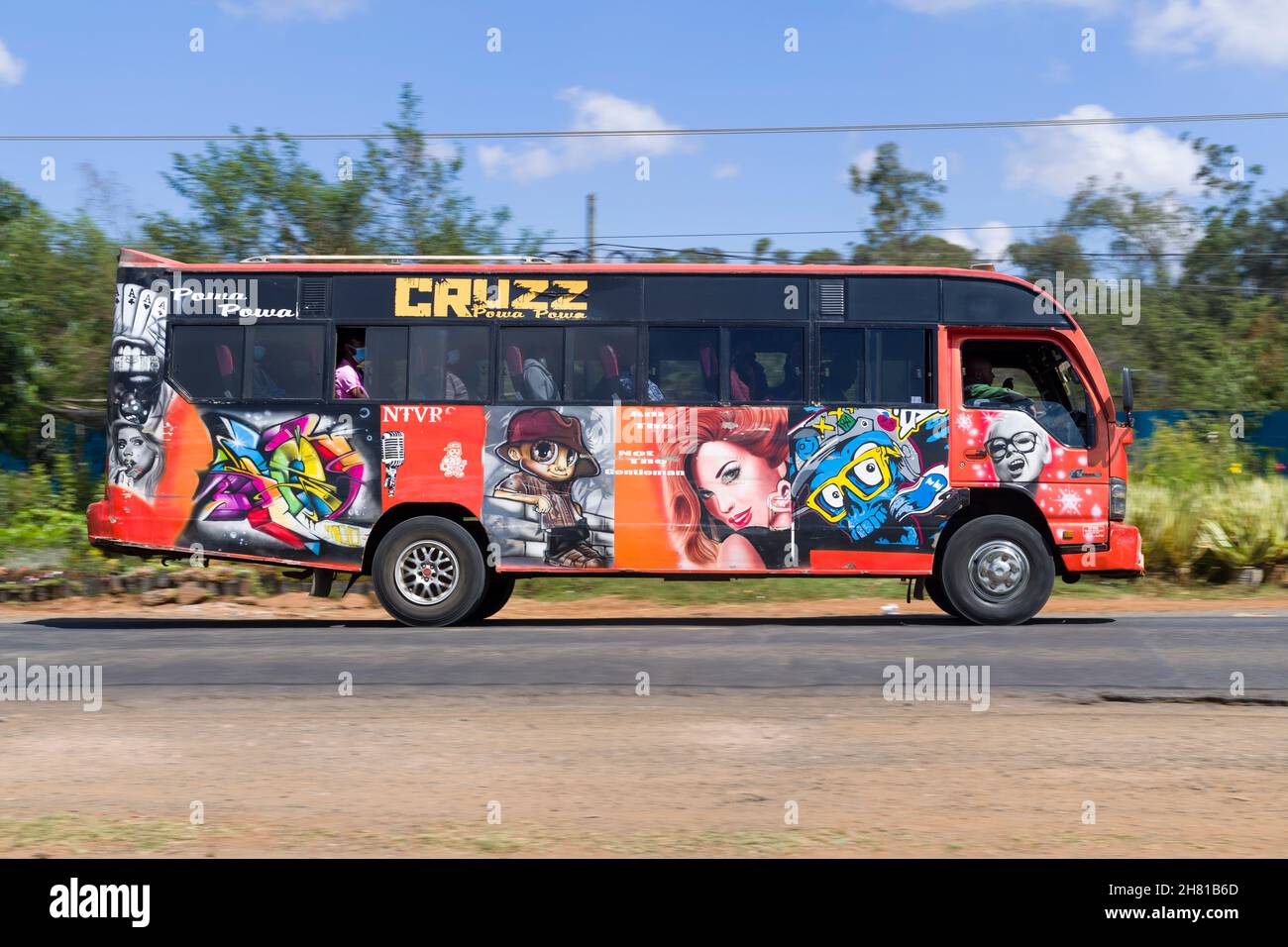 Bus with customised paintwork driving along Ngong road. Many buses in ...