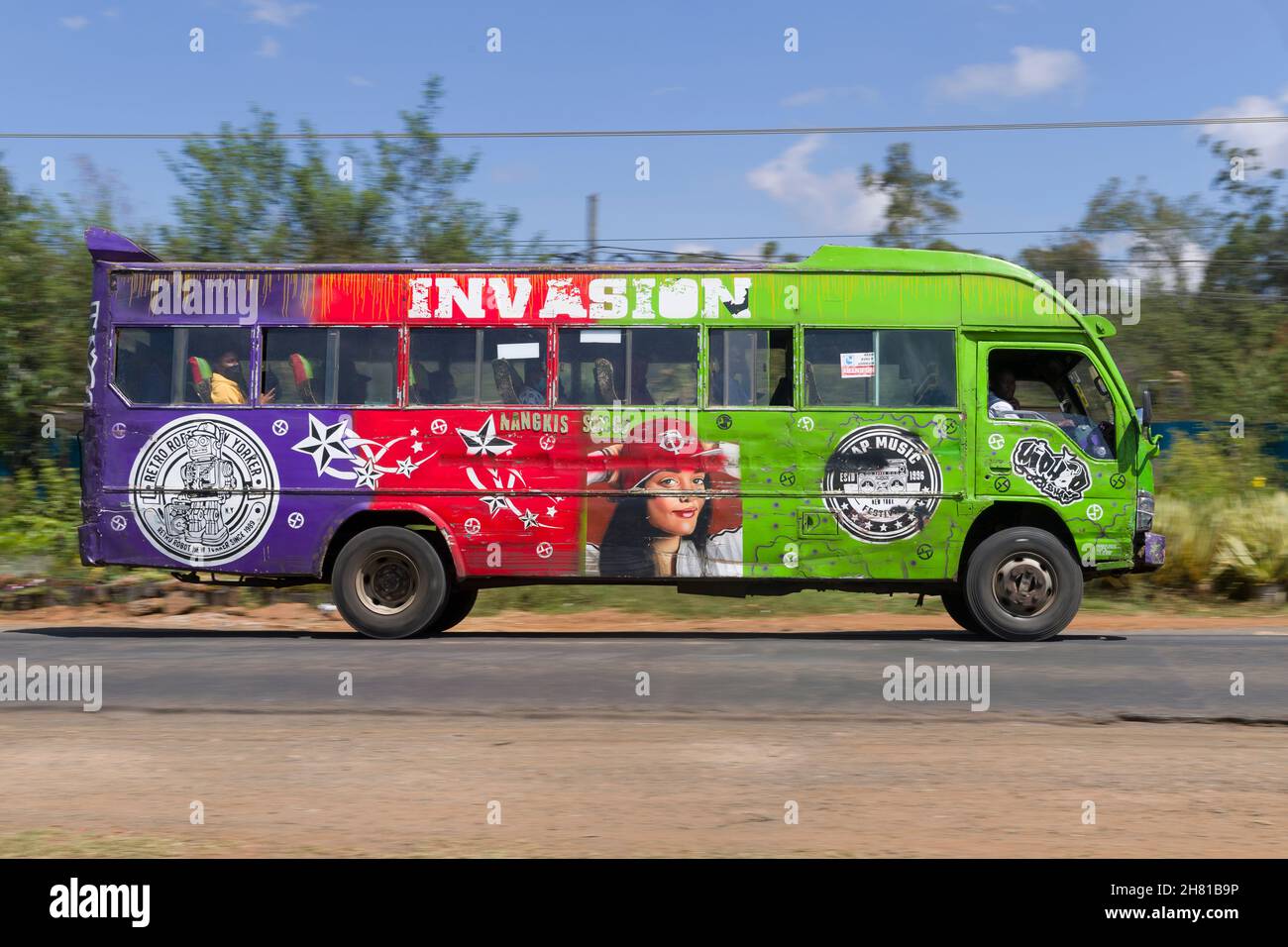 Bus with customised paintwork driving along Ngong road. Many buses in ...