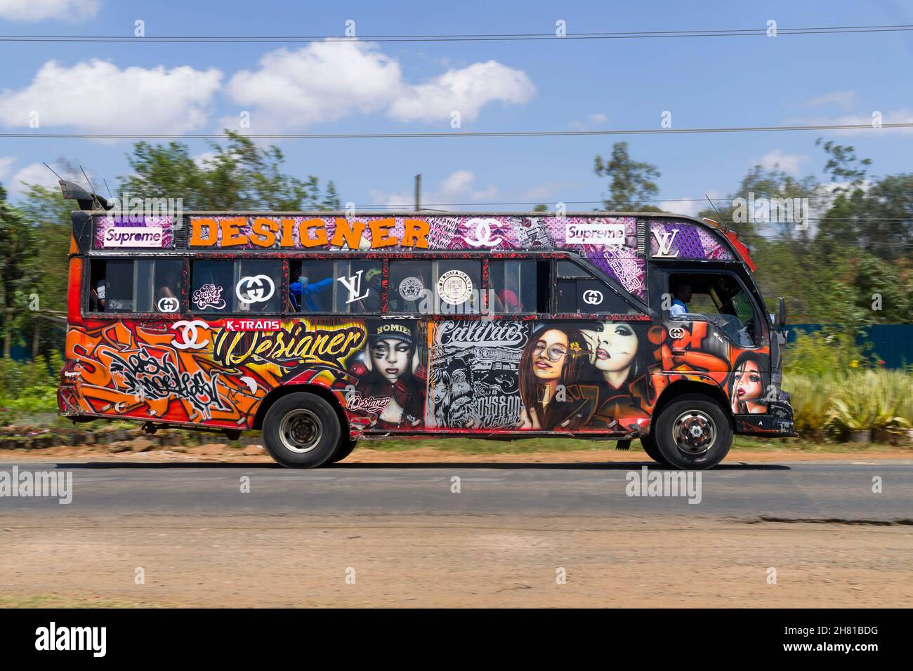 Bus with customised paintwork driving along Ngong road. Many buses in ...