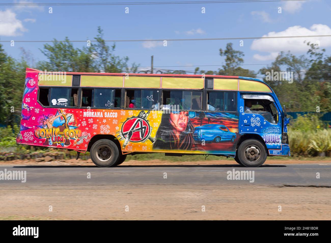 Bus with customised paintwork driving along Ngong road. Many buses in ...