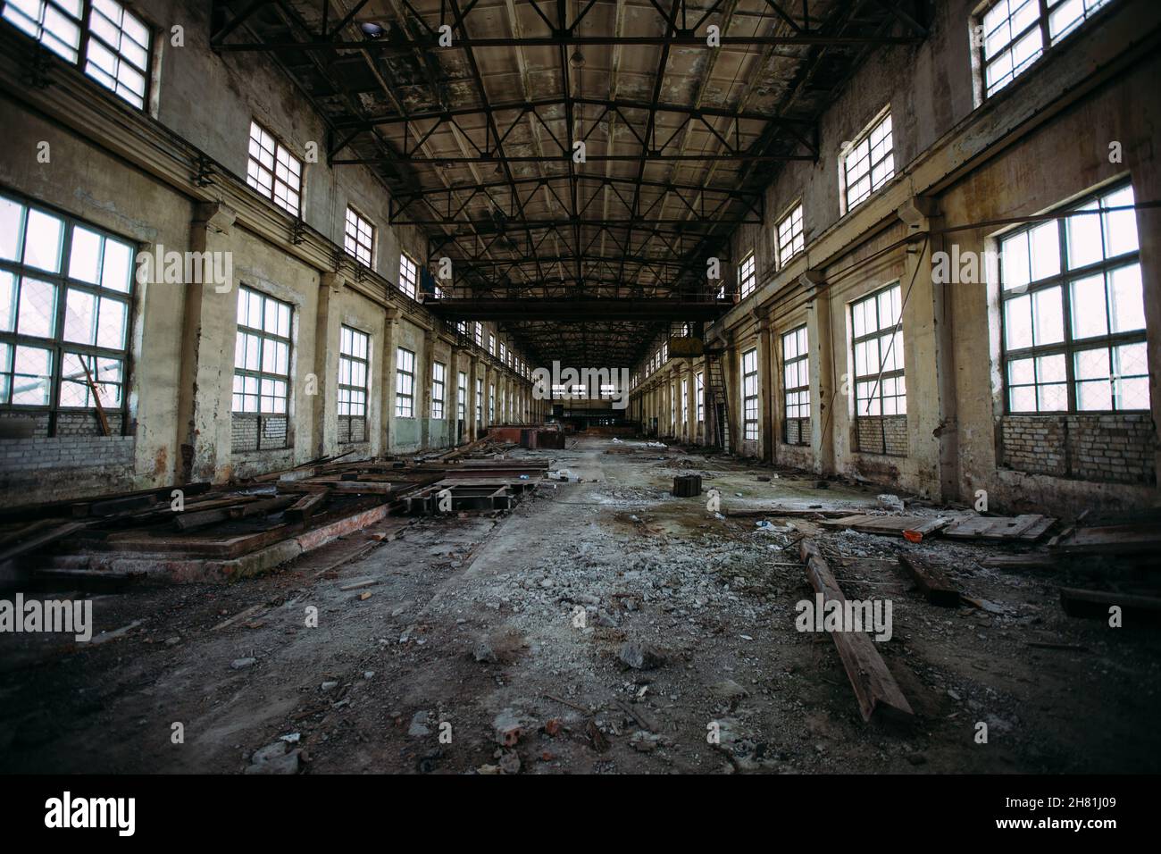 Abandoned factory. Large empty industrial hall with garbage Stock Photo ...