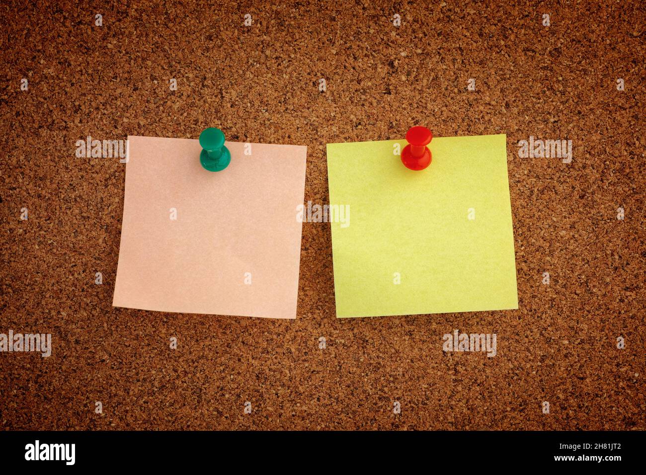 Two blank sticky notes pinned to a cork board. Close up Stock Photo - Alamy