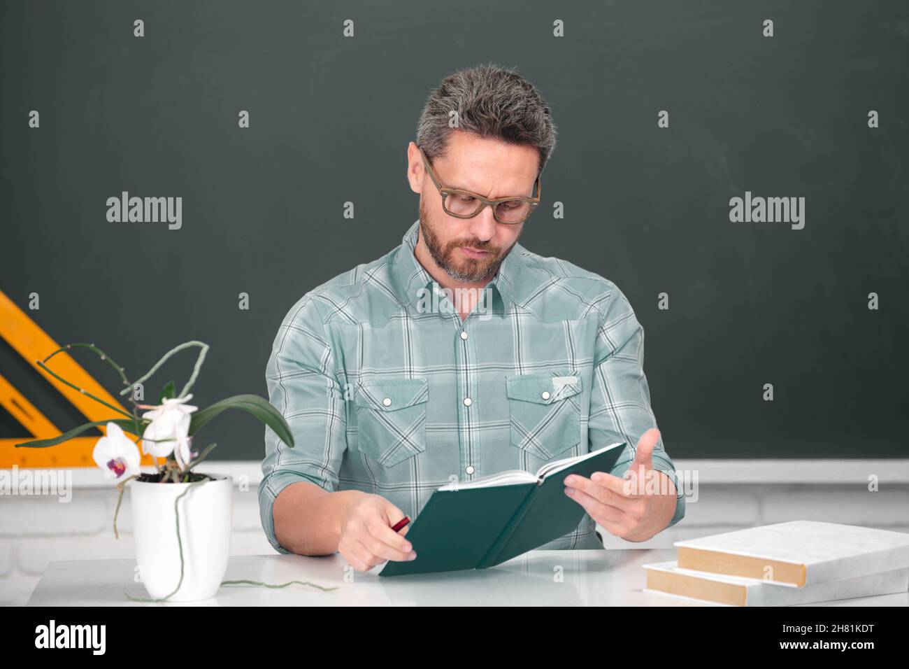 Portrait of male teacher teaching line of high school students with ...