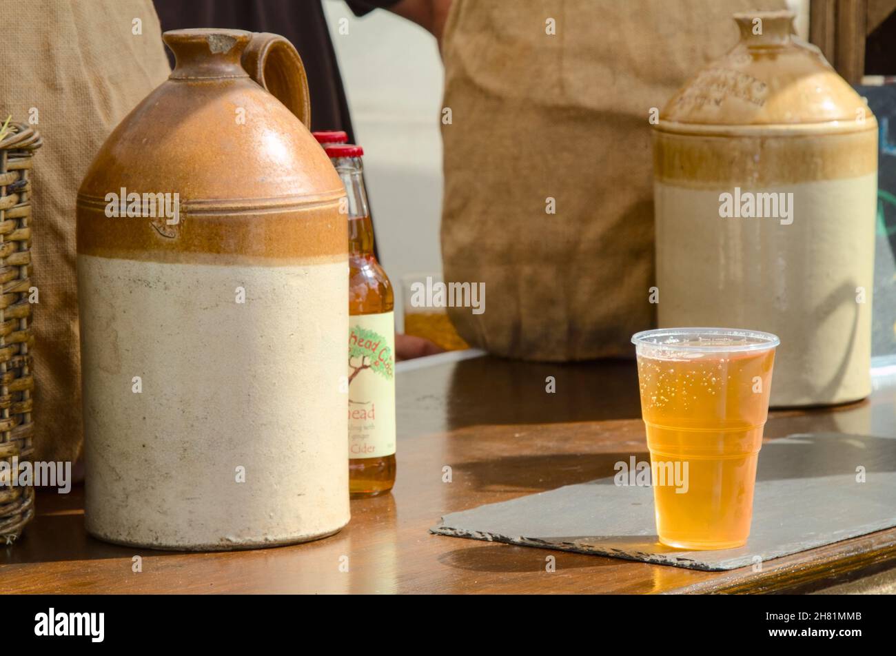 Plastic Glass With Cider On A Market Stall With Stoneware Pottery Demi ...