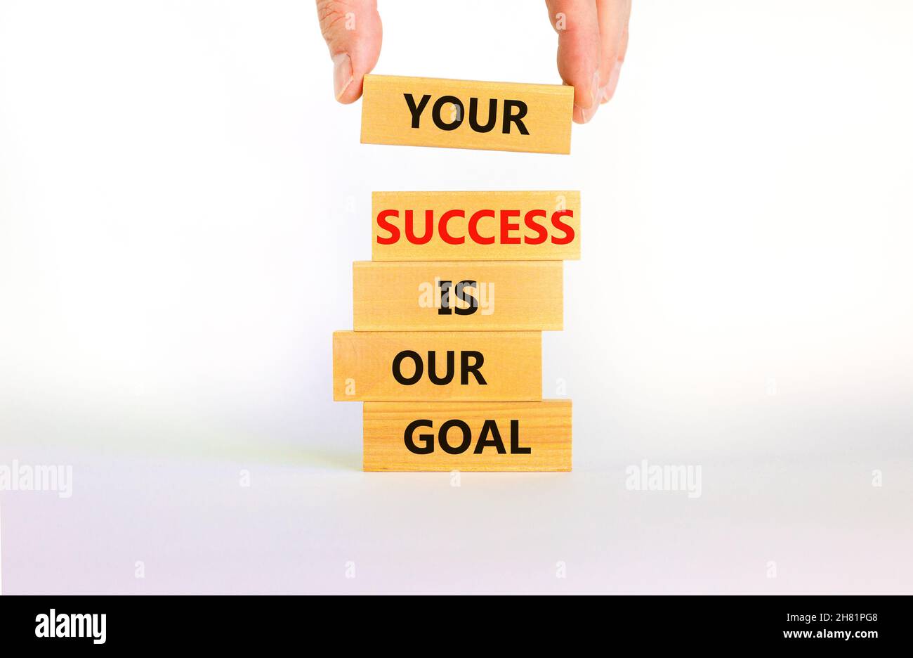 Your success is our goal symbol. Wooden blocks with words 'your success is our goal ...