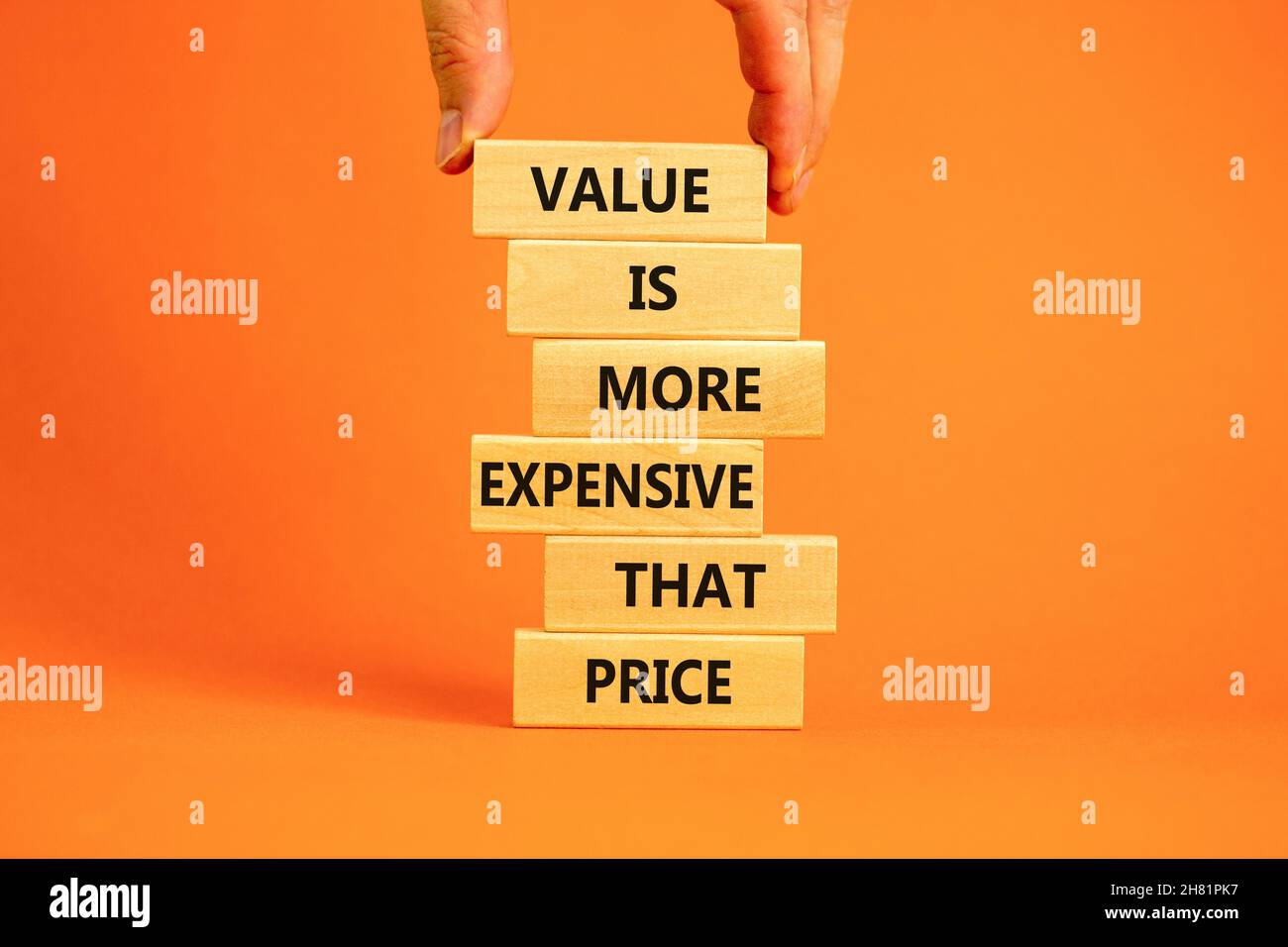 Price or value symbol. Wooden blocks with concept words Value is more ...