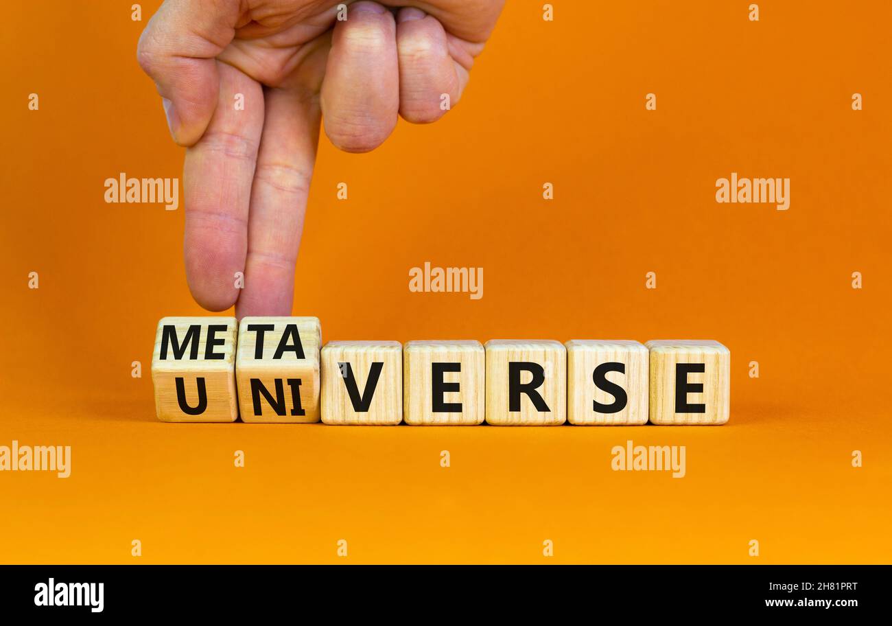 Universe or metaverse symbol. Businessman turns wooden cubes and ...