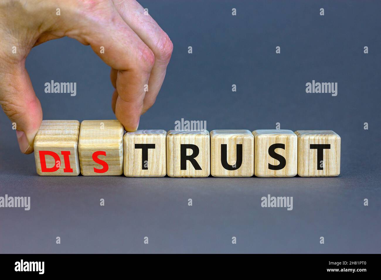 Distrust or trust symbol. Businessman turns wooden cubes, changes words ...