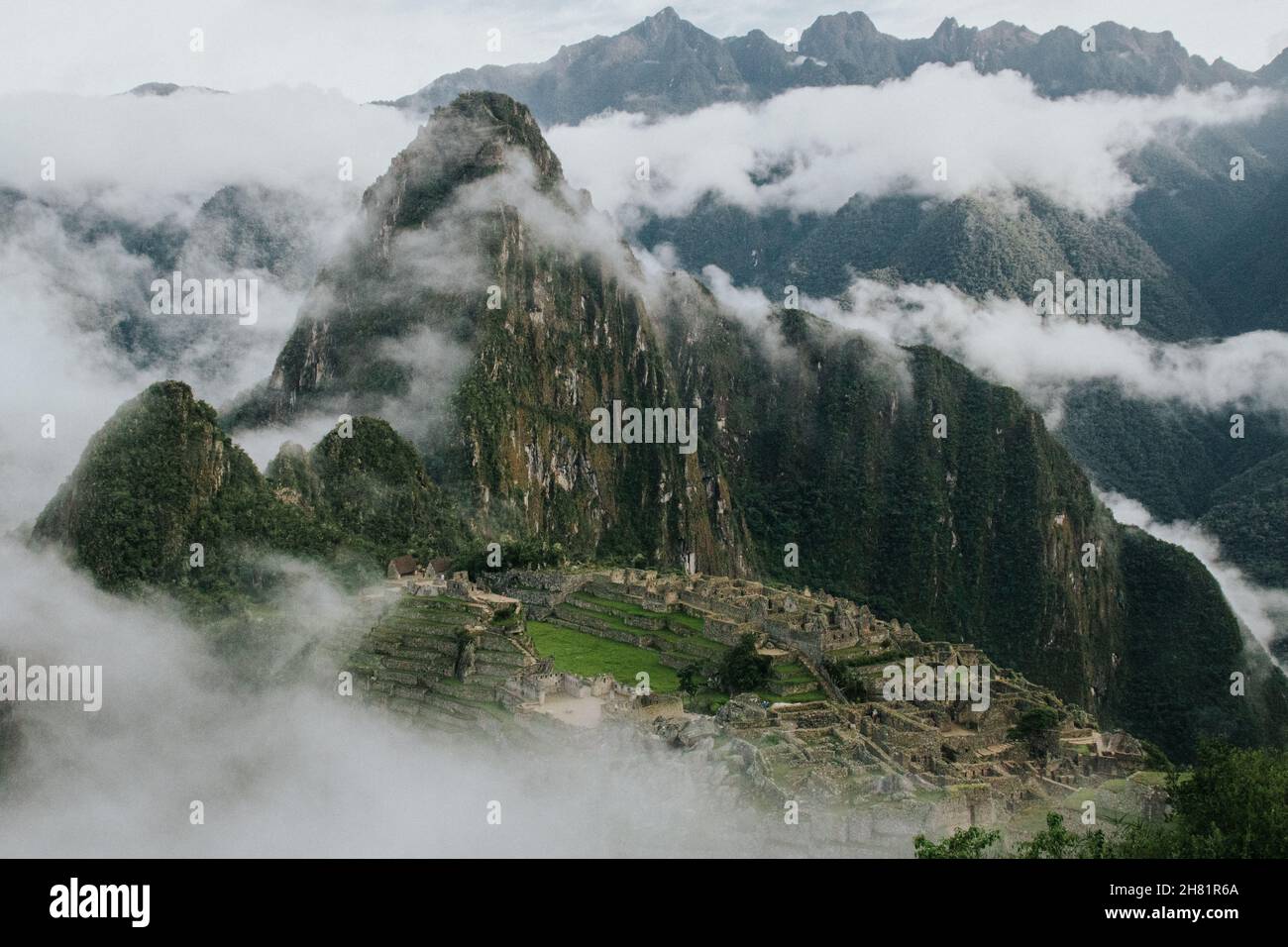 Beautiful view of Machu Picchu ruins under a cloudy sky in Peru, South ...