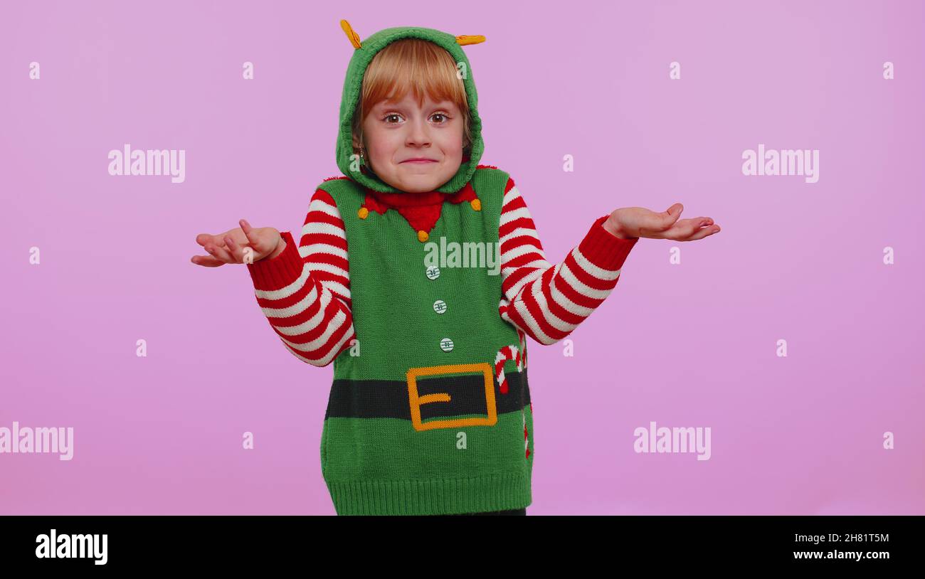 Confused girl in Christmas costume feeling embarrassed about ambiguous ...