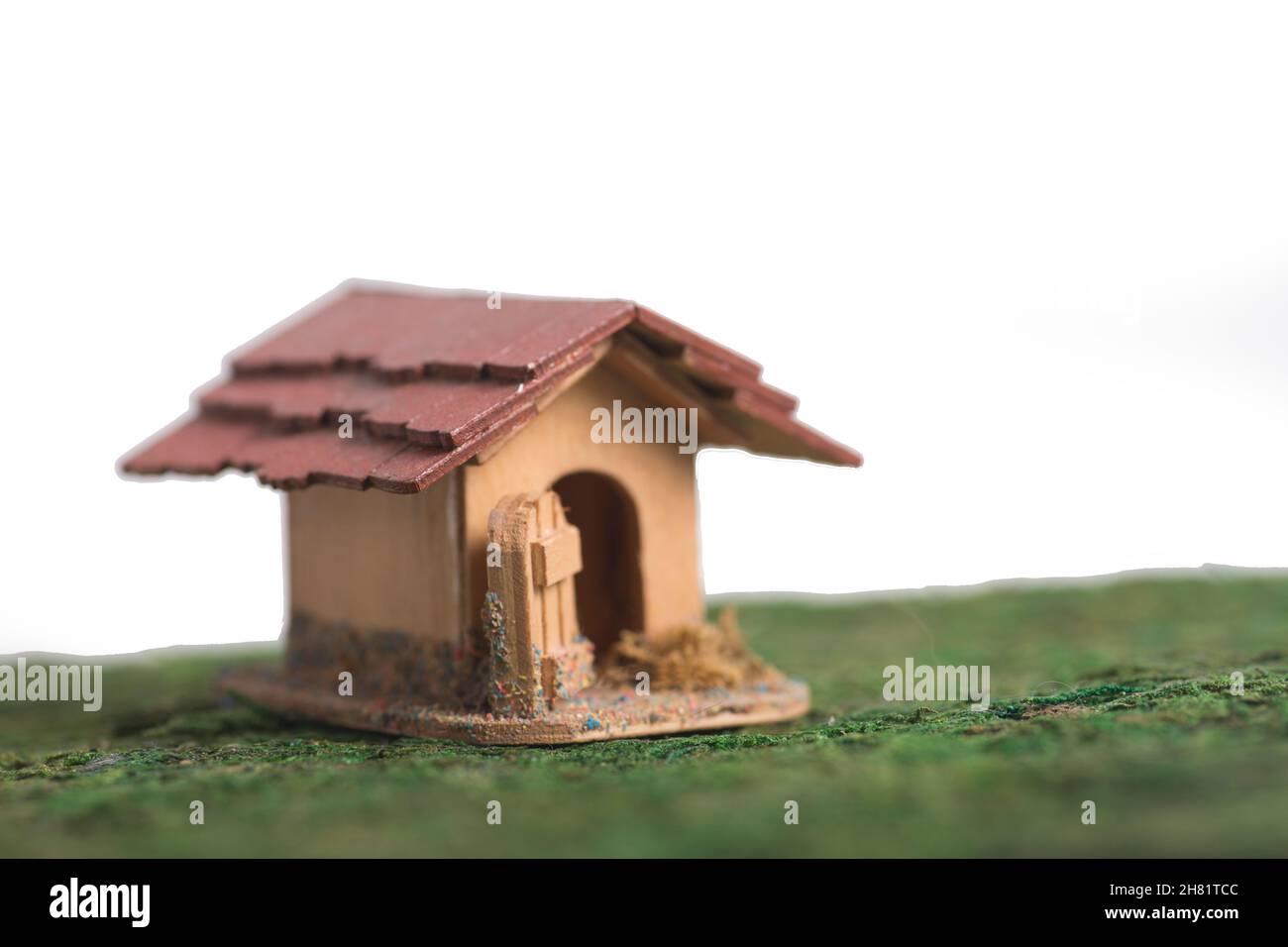 rural living concept - small house on green lawn against white ...