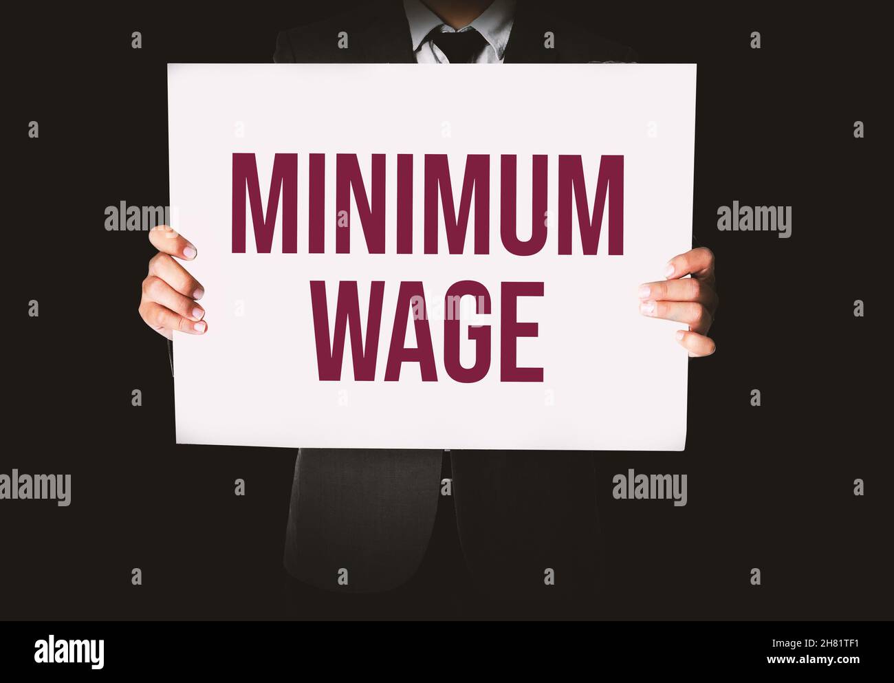 Minimum Wage Concept Background with Employee Holding Cardboard Stock ...