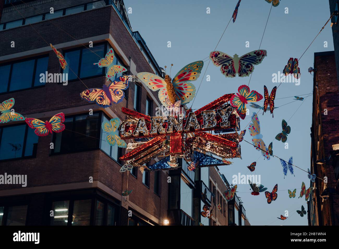 London, UK - November 23, 2021: Shimmering Carnaby sign surrounded by ...