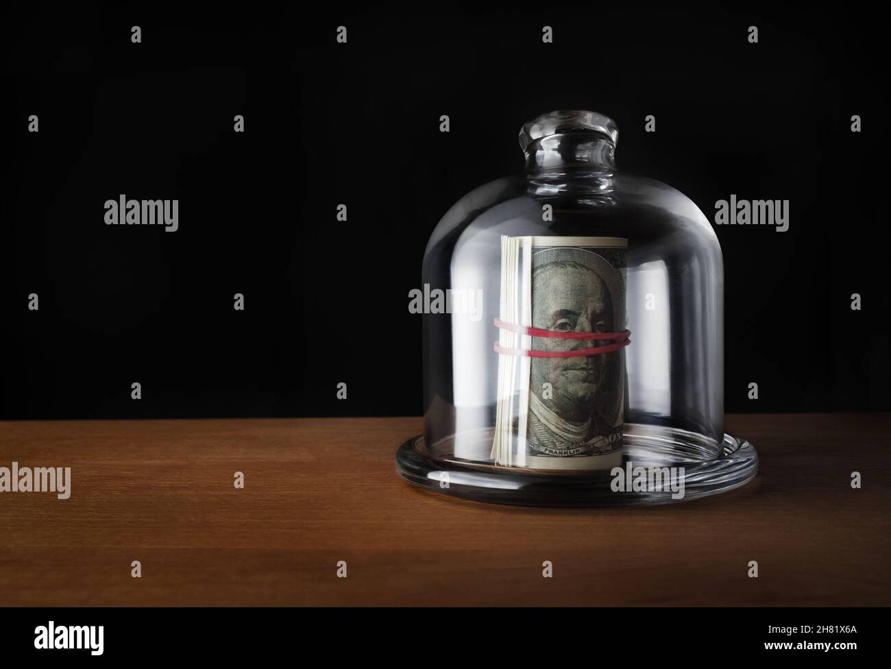 Saving money concept. Dollars under glass cap. Copy space Stock Photo ...