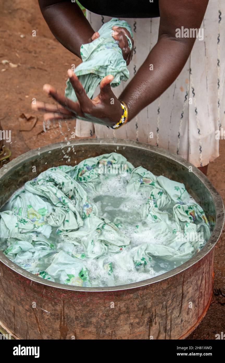 a woman in Africa hand washing clothes Stock Photo - Alamy