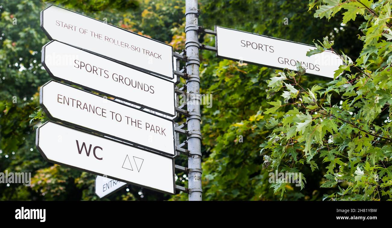 Signs in the park show directions where objects and entertainment are ...