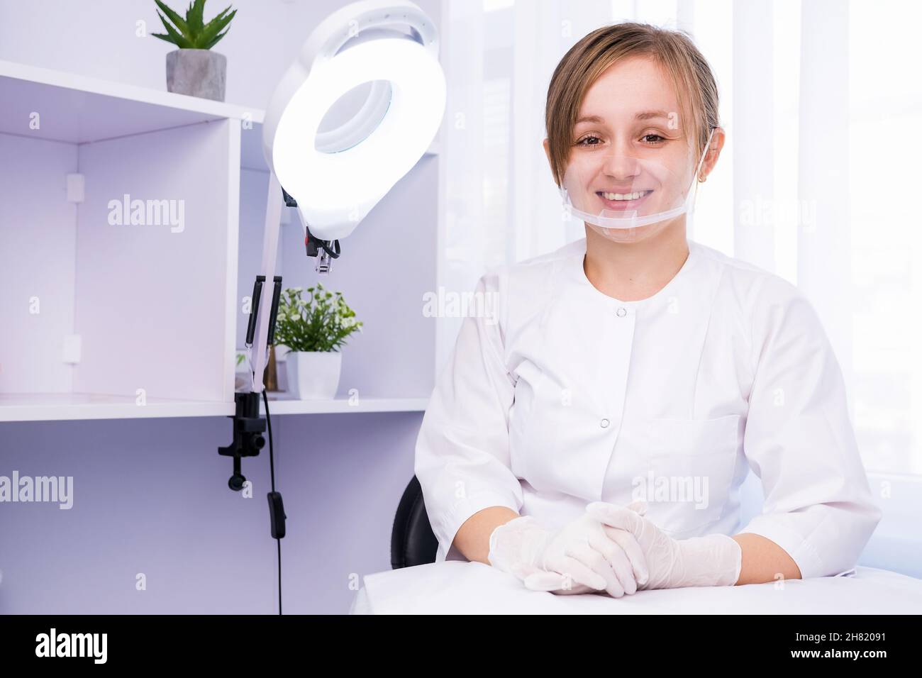 Close up photo of a young beautiful professional cosmetologist woman ...