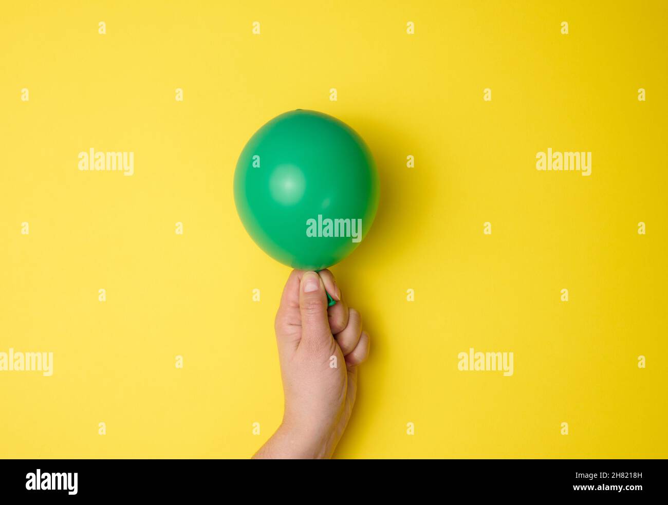 Female hand holding inflated yellow hi-res stock photography and images ...