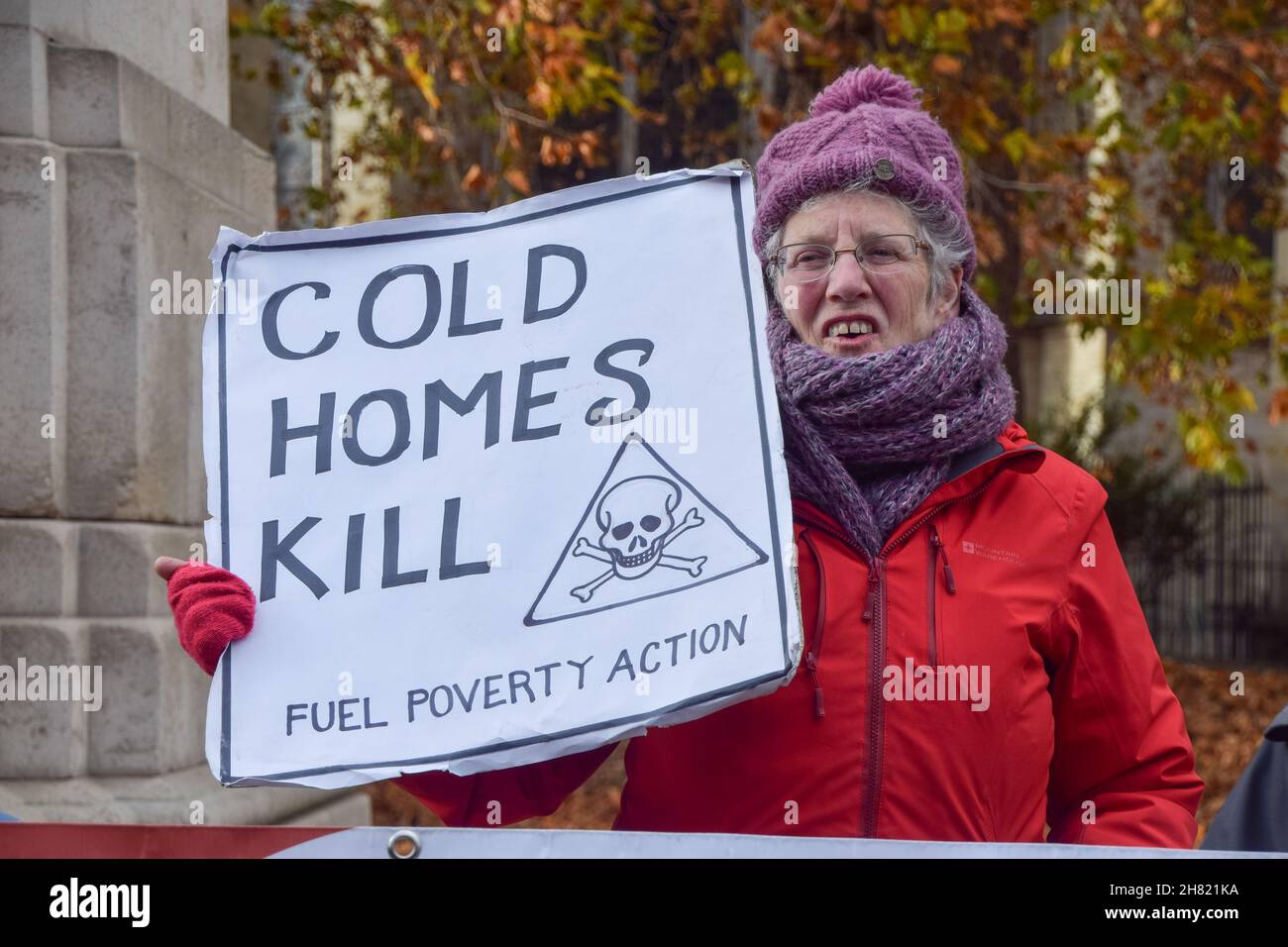 London, UK. 26th Nov, 2021. A protester holds a 'Cold Homes Kill ...