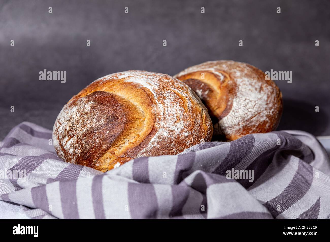 mixed wheat german bread Fresh loaf on a dark background. Traditional ...