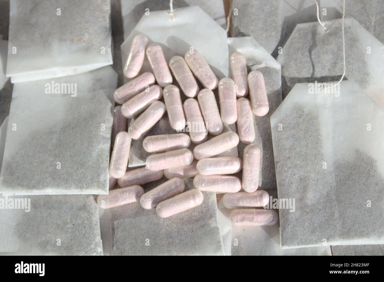 tea bags and pink capsules Stock Photo - Alamy