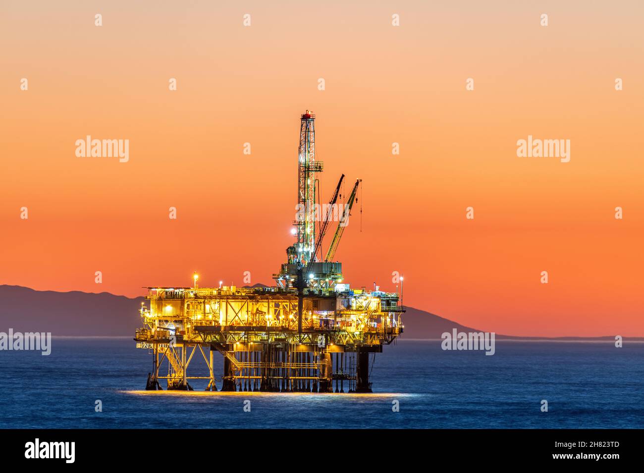 Offshore oil platform off the coast of California against a moody ...
