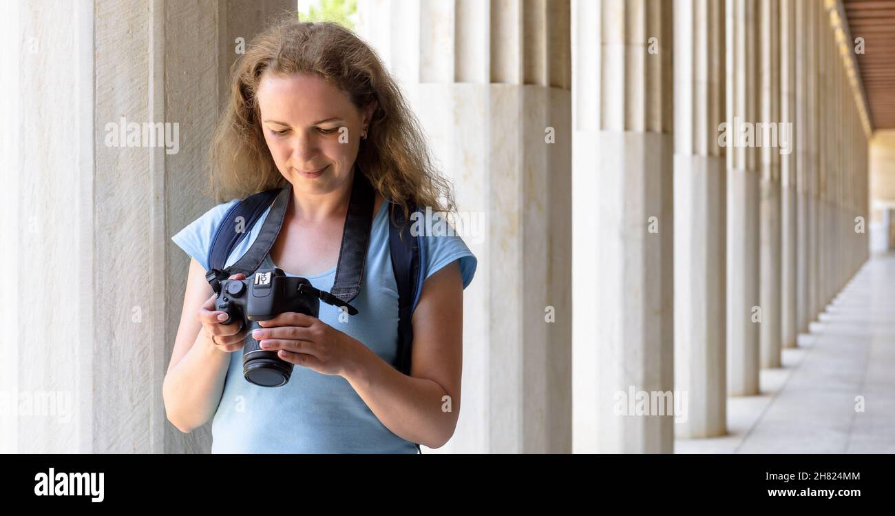 Tourist plays photos in camera at Ancient Greek columns, Athens, Greece ...