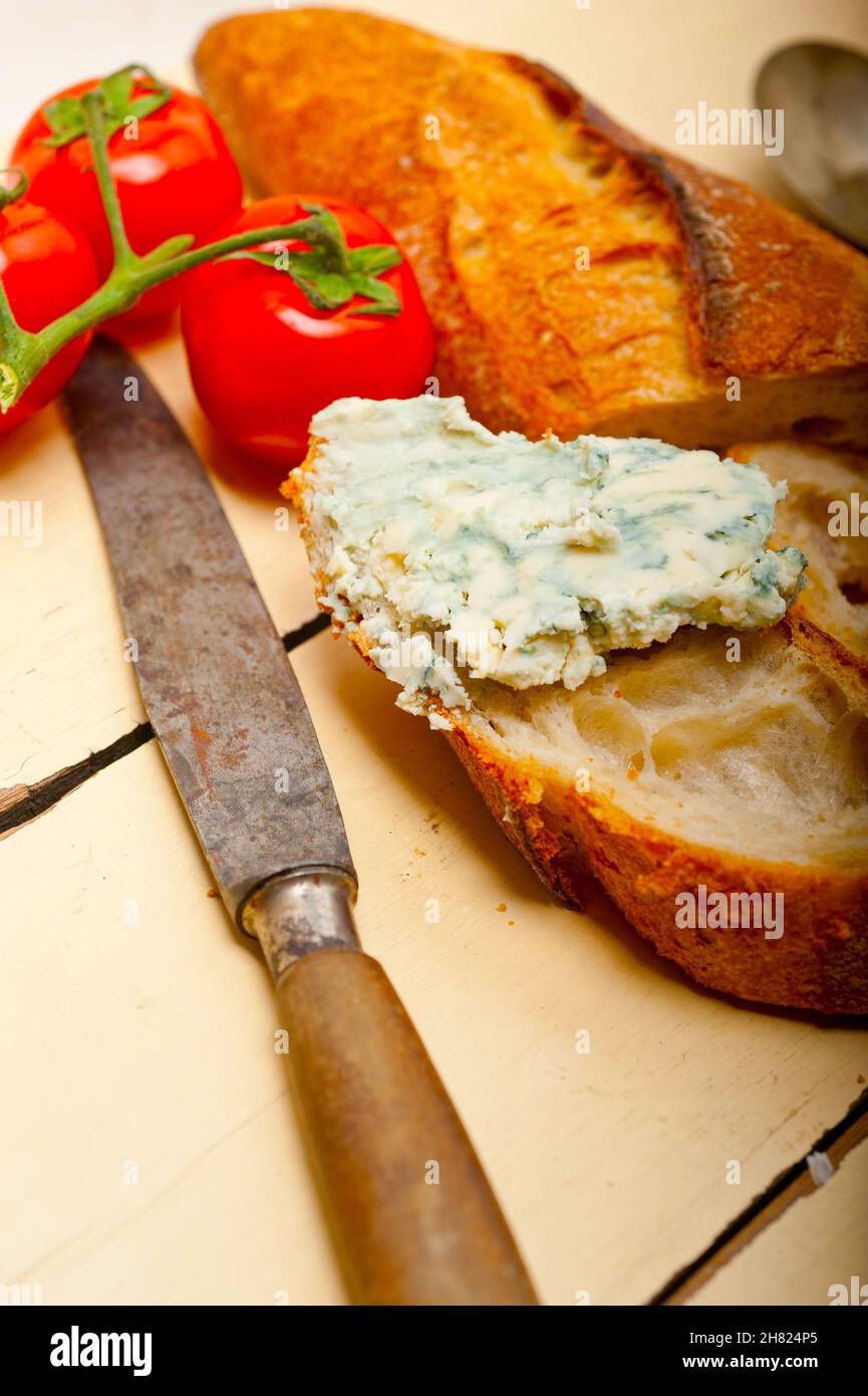 fresh blue cheese spread ove french baguette with cherry tomatoes on ...