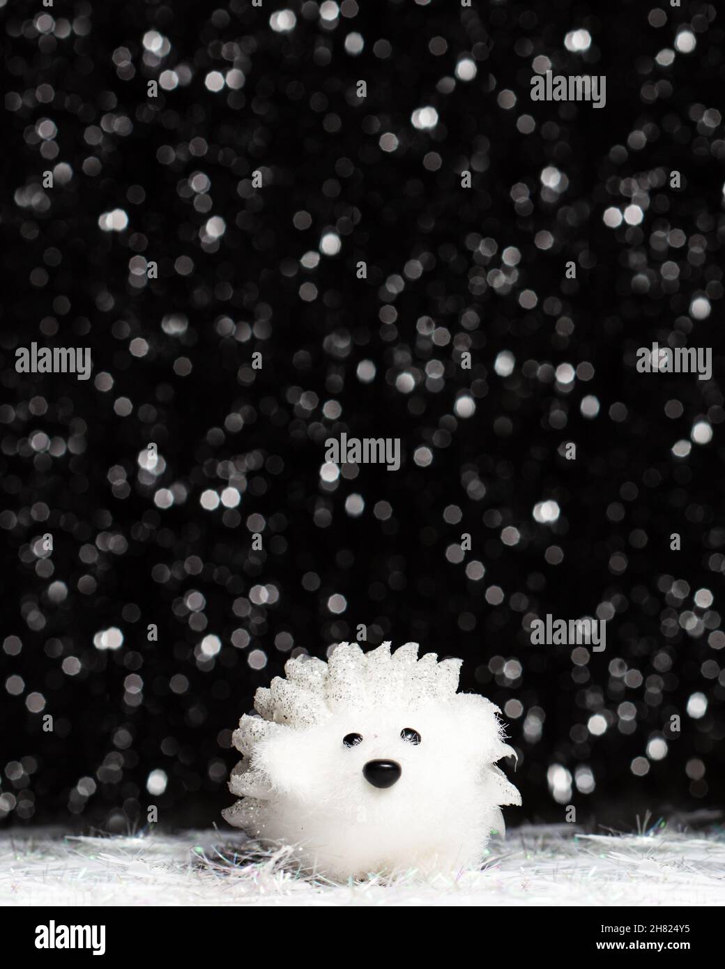 Christmas decorations view of white artificial hedgehog on dark ...
