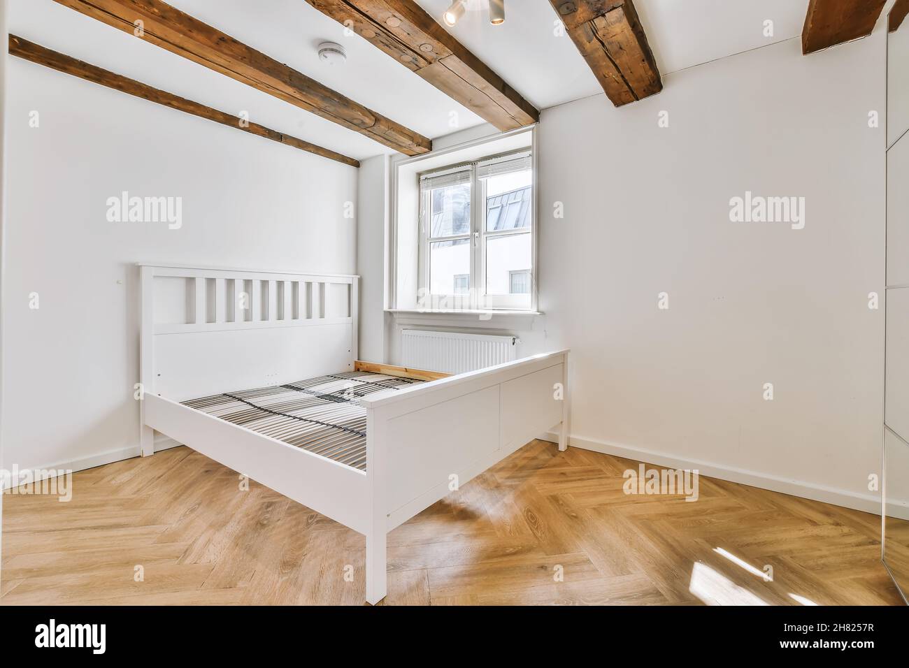 Beautiful bright bedroom without a mattress on the bed Stock Photo - Alamy