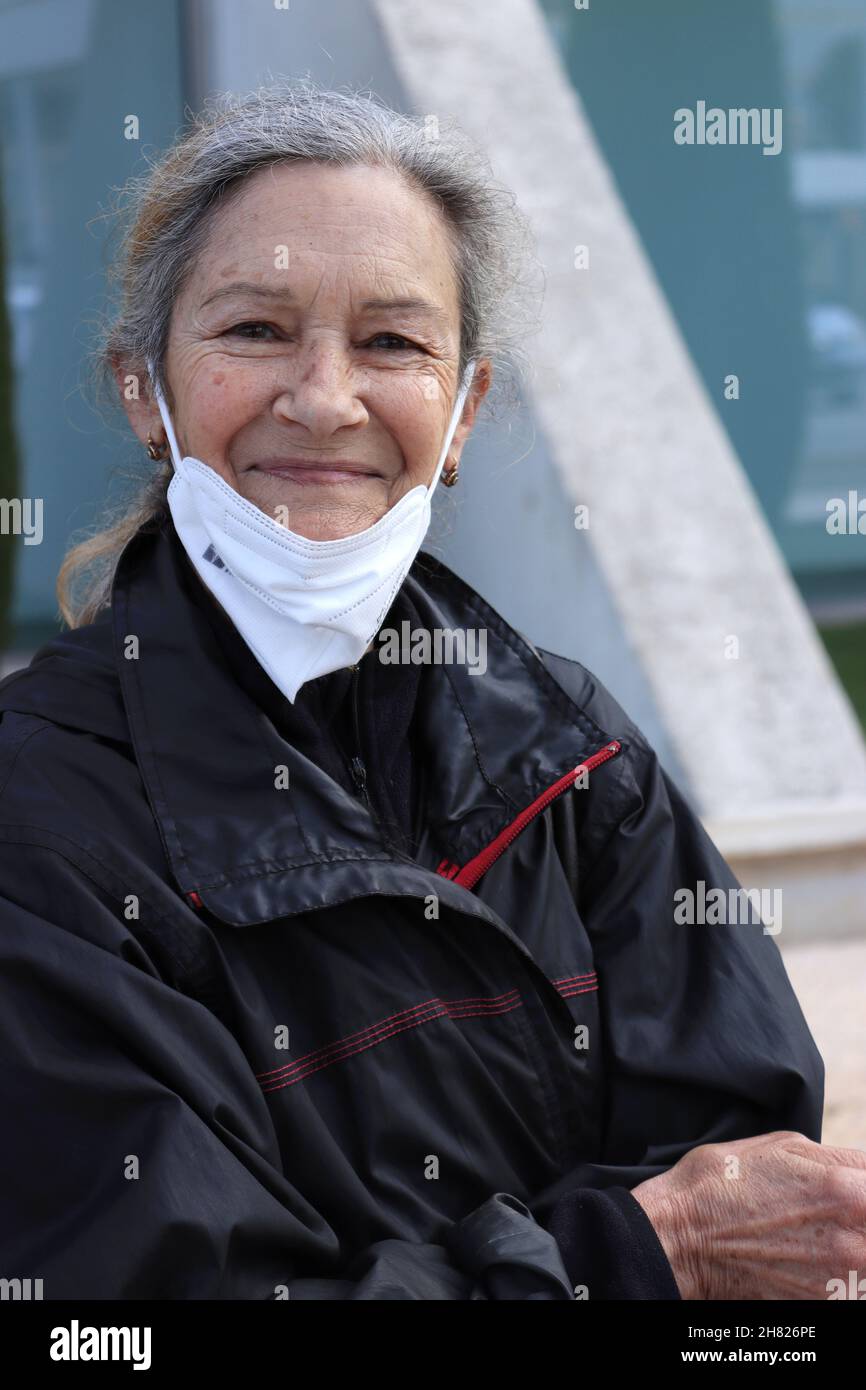 older woman smiling with the mask Stock Photo - Alamy