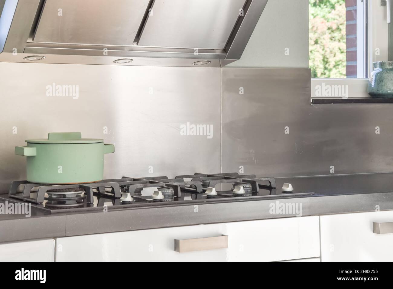 Modern gas stove with ceramic green cauldron Stock Photo - Alamy
