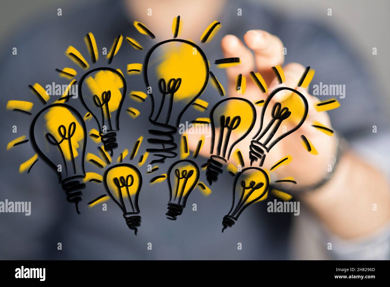 Entrepreneur tapping on a hologram of lightbulbs - business innovation ...