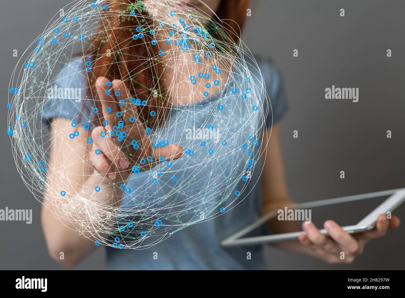 Businesswoman tapping on a 3D rendering of a global network hologram ...