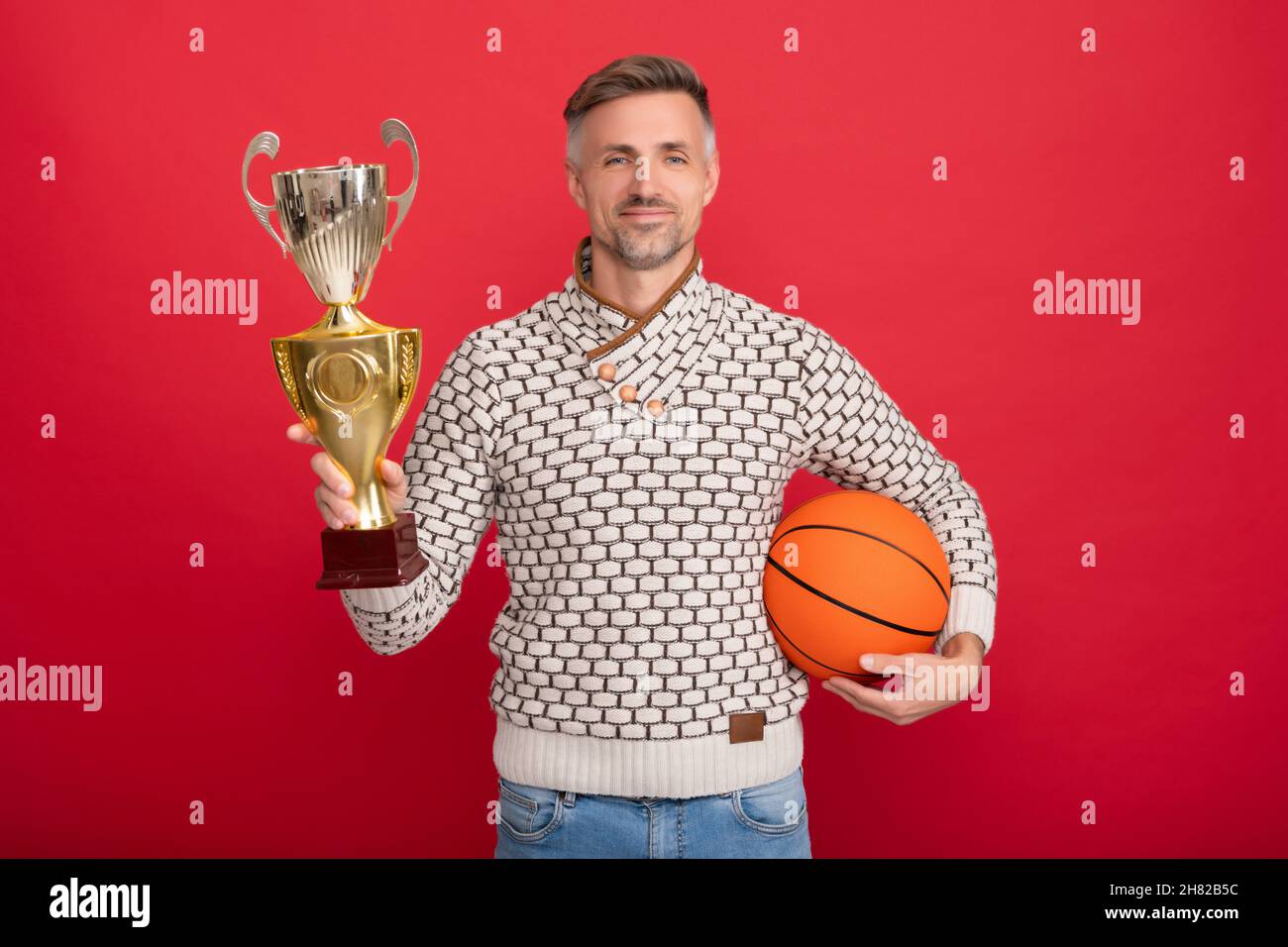 Happy man win basketball cup prize red background, winner Stock Photo ...