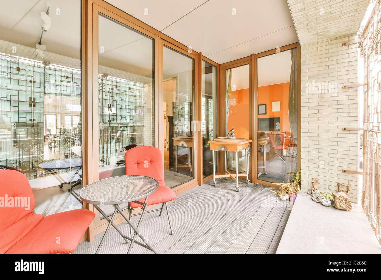 Pretty balcony design with two red chairs and coffee table Stock Photo ...