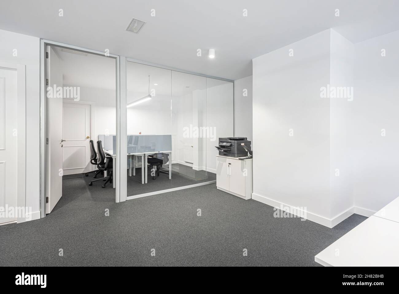 offices with glass chambers in a telecommuting office Stock Photo - Alamy