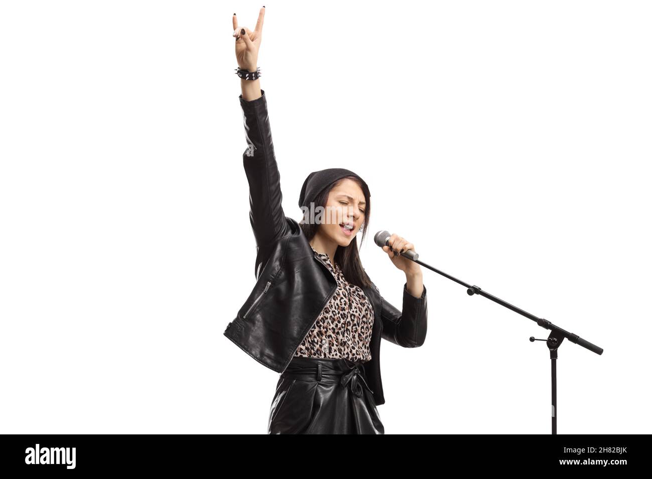 Female singer singing on a microphone and gesturing rock and roll sign ...