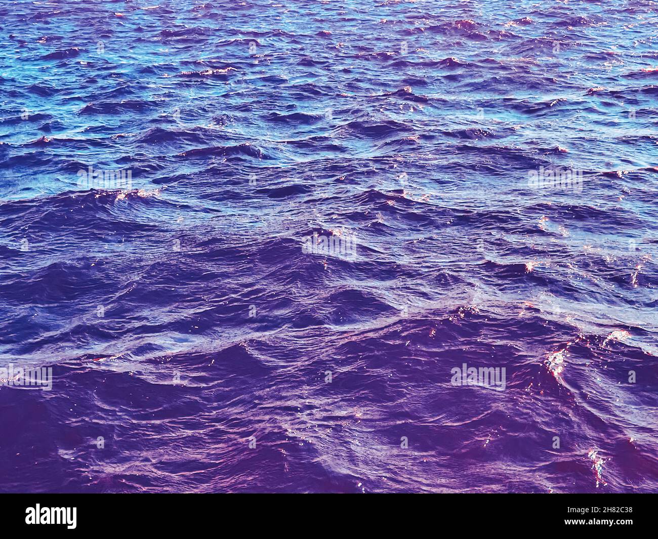 Sea, texture and coastal nature concept. Ocean water at sunset as ...