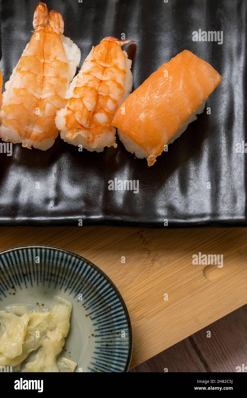 Pieces of Japanese nigiri with salmon, prawns and white rice with ...