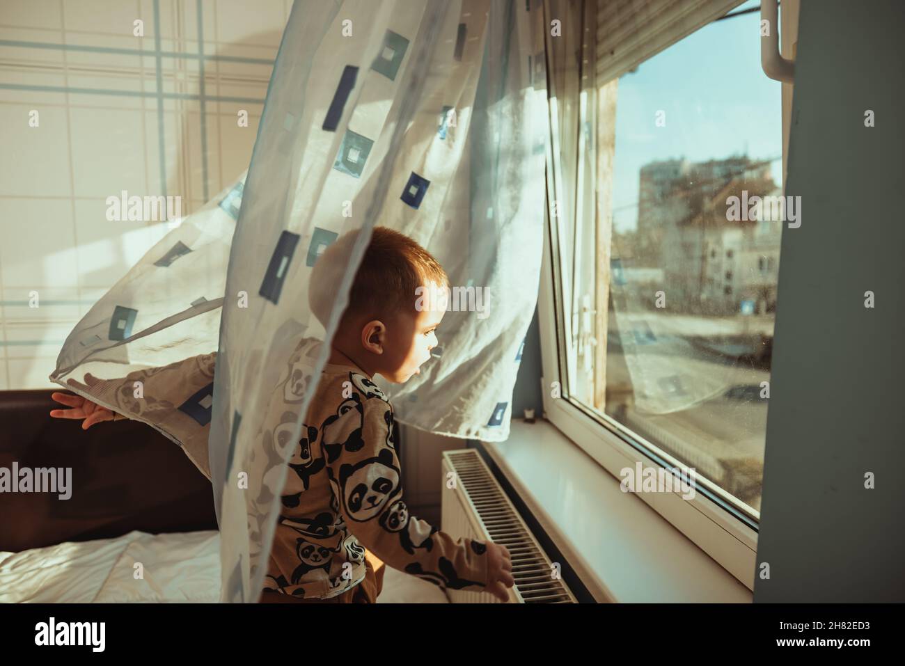 Boy staring out window hi-res stock photography and images - Alamy